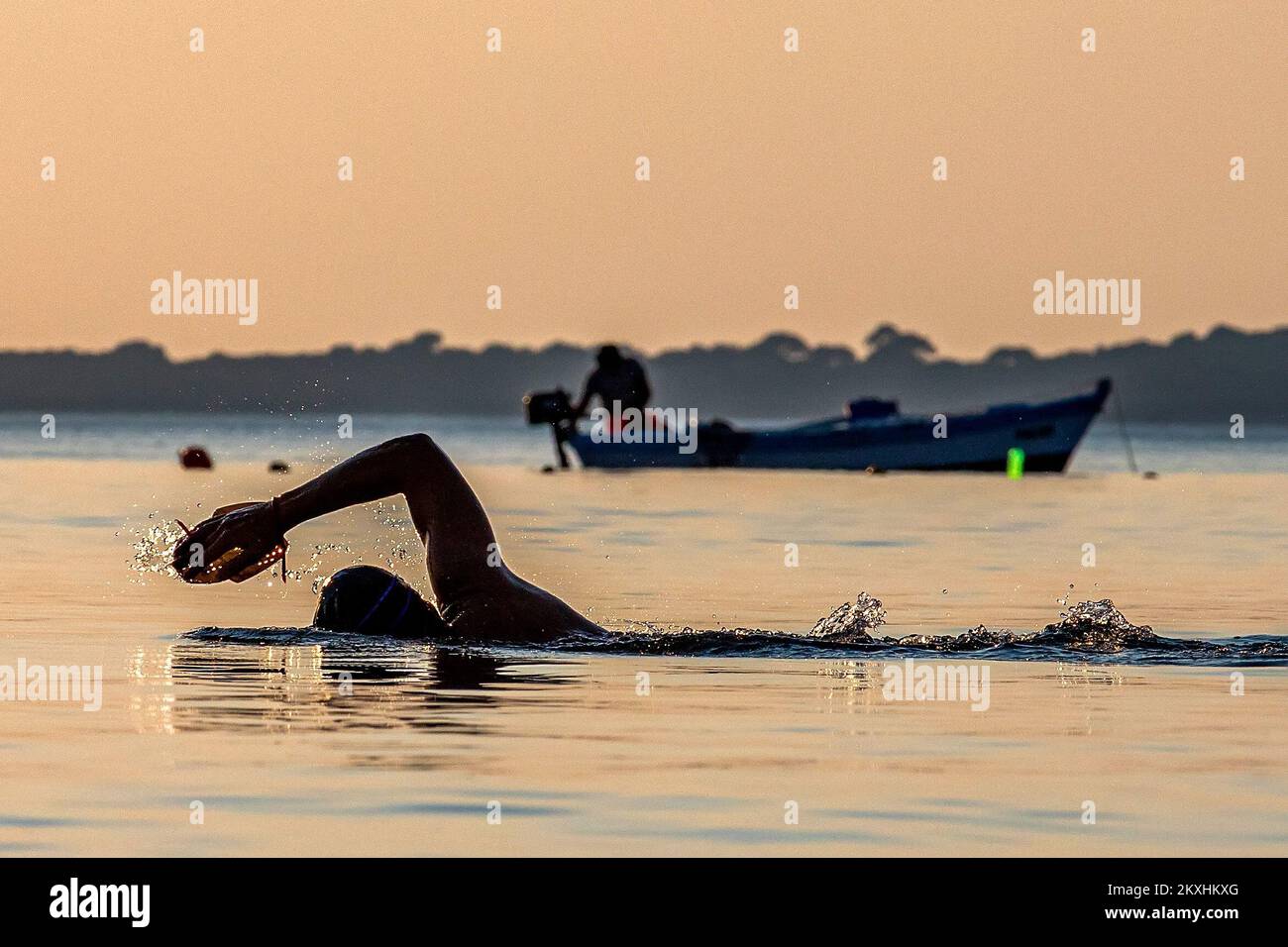 The man seen in the twilight swim in the Fazana Channel in Fazana ...