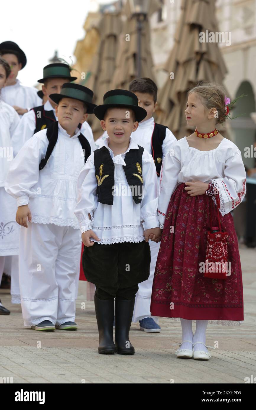 Participants dressed in traditional folk costumes during the parade of ...