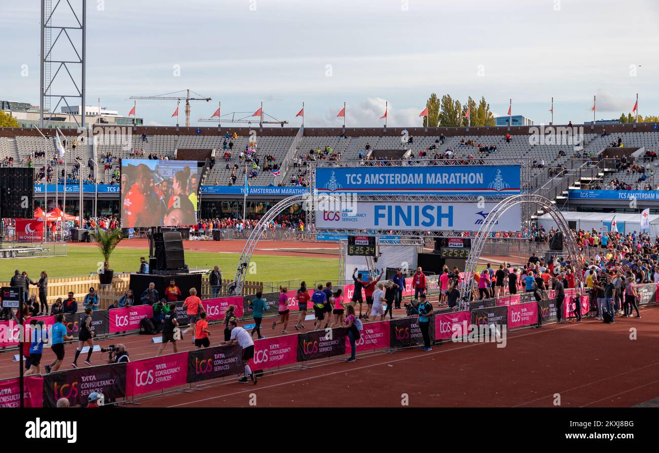 A picture of multiple runners on the finish line of the Amsterdam ...