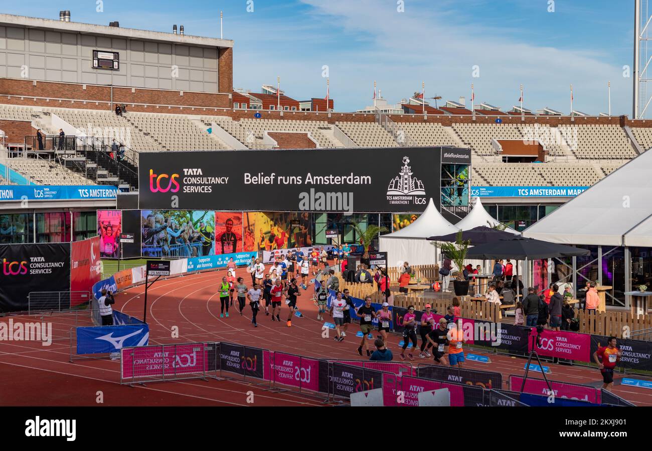 A picture of multiple runners on the finish line of the Amsterdam ...