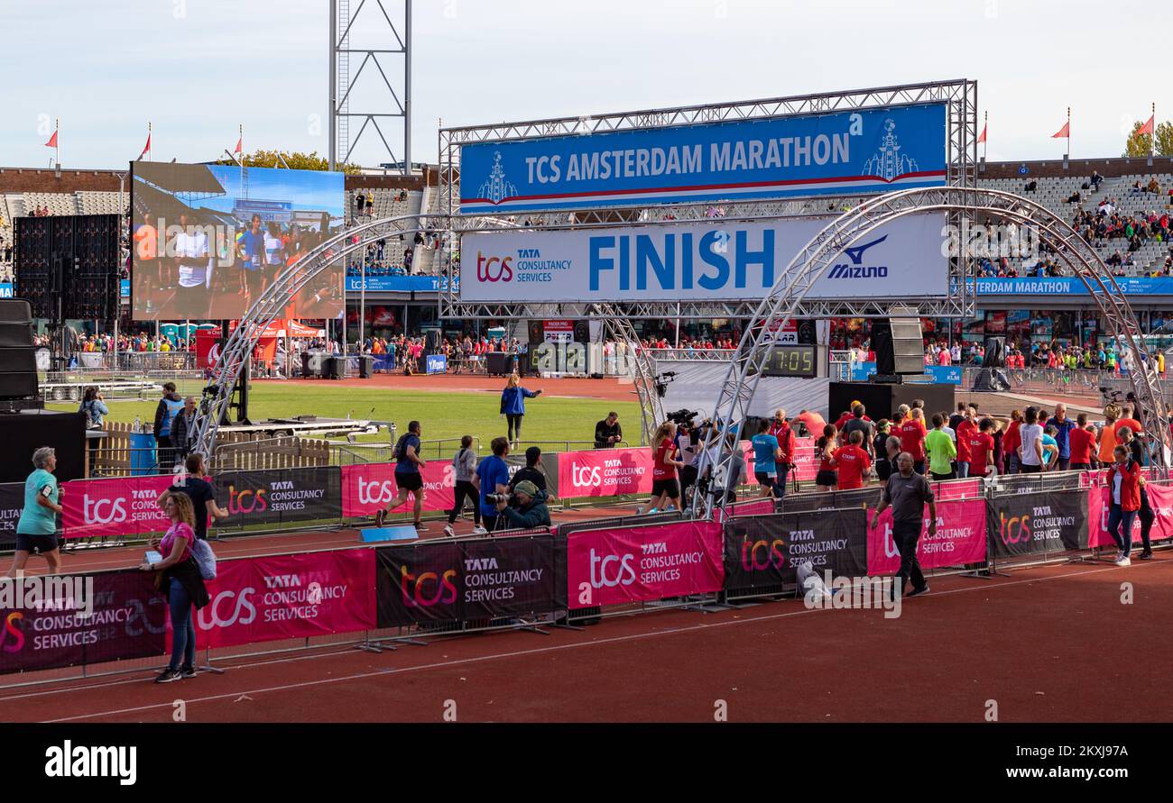 A picture of multiple runners on the finish line of the Amsterdam ...