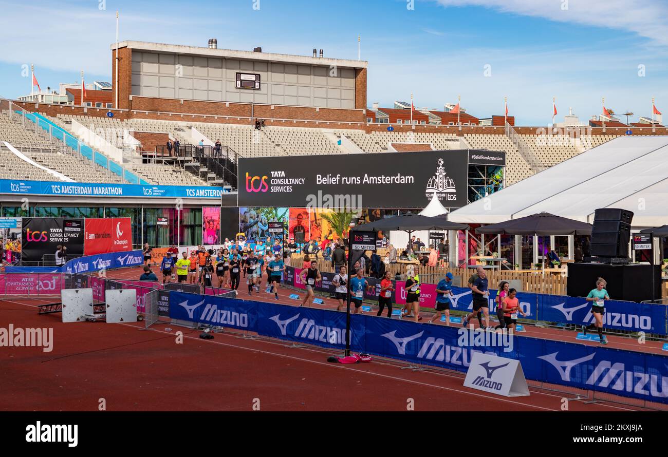 A picture of multiple runners on the finish line of the Amsterdam ...