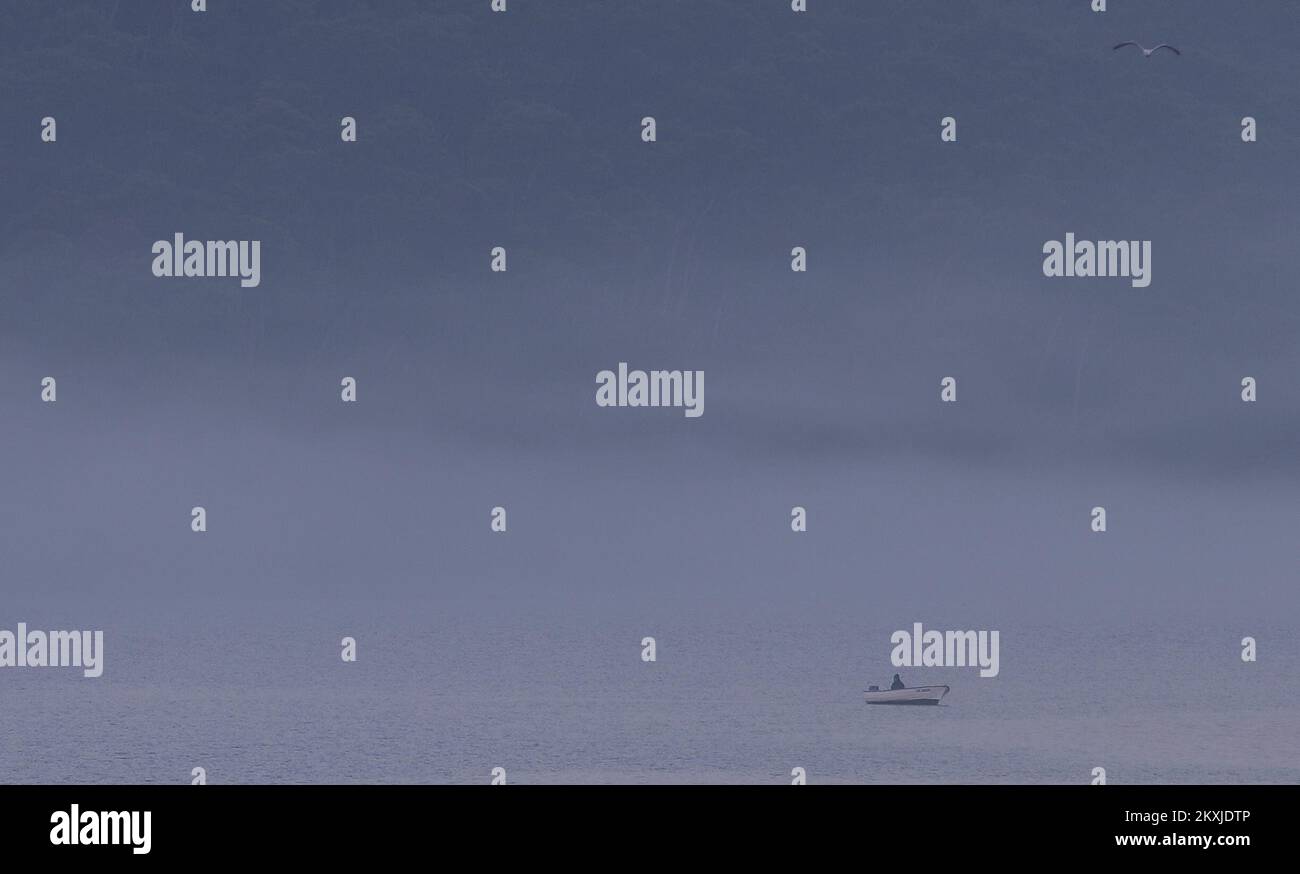 The pictures show a mystical morning with fog and a full moon on the ...