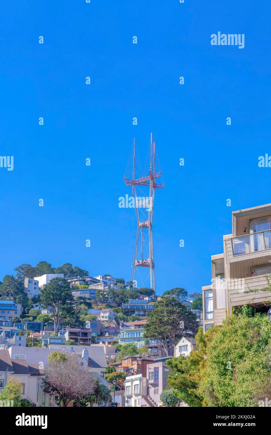 Peak of Sutro Tower above the hill with houses on the slope at San ...
