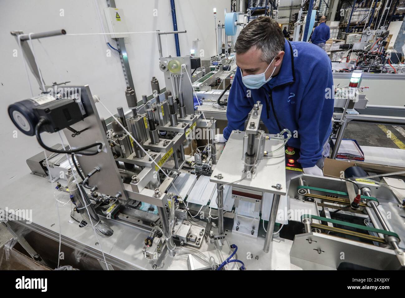 Factory worker oversees production of surgical masks, in Zagreb ...