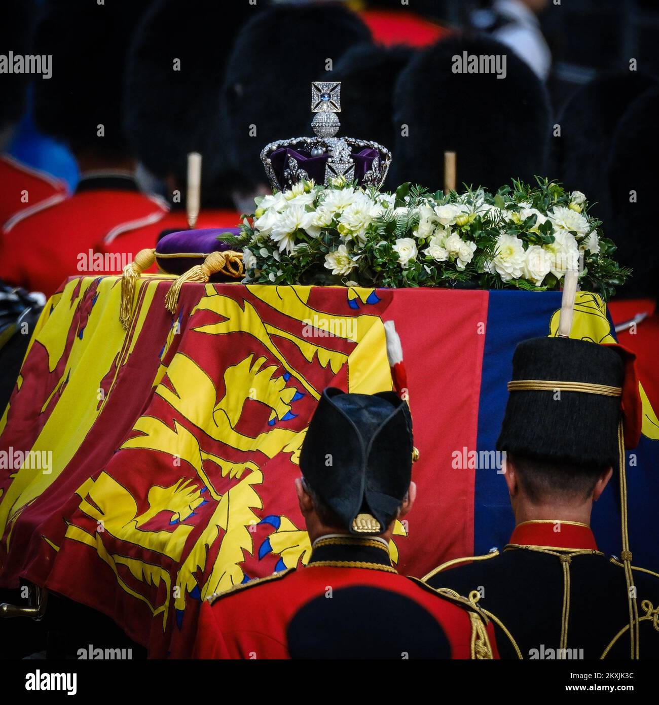 The coffin is adorned with the Royal Standard , Imperial State Crown ...