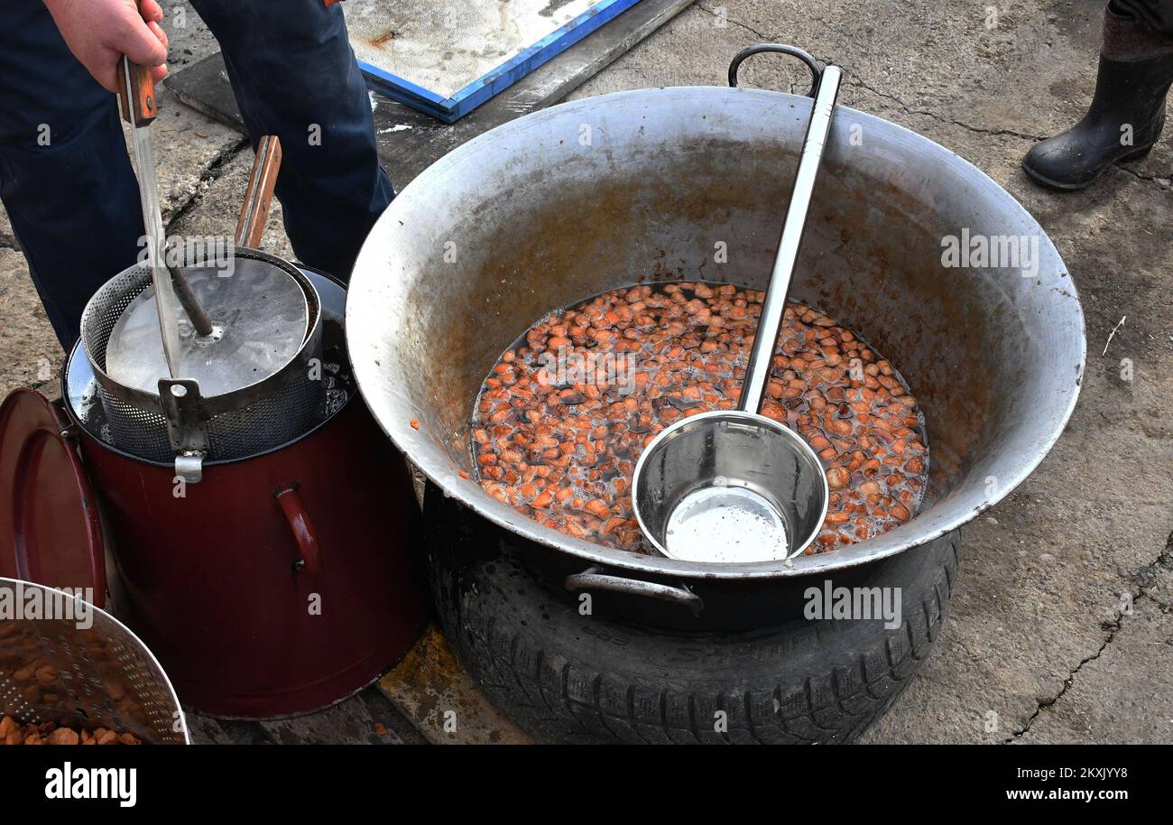 Cracklings are pictured while melted during traditional Slavonian pig ...