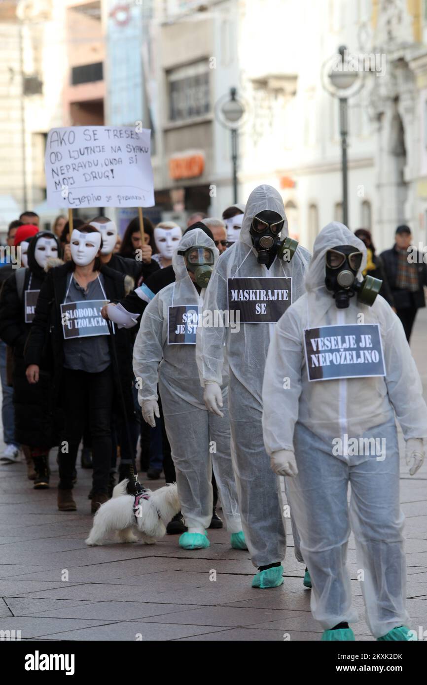 People in protective suits and with masks on their faces can be seen in ...