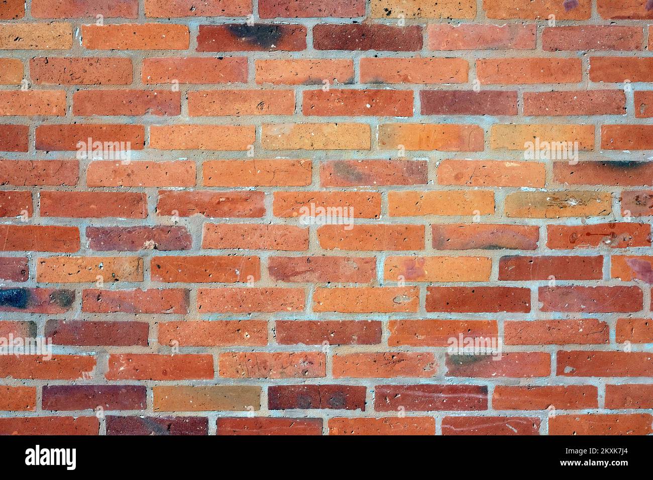 Part of red bricks wall with concrete joints as background front view ...