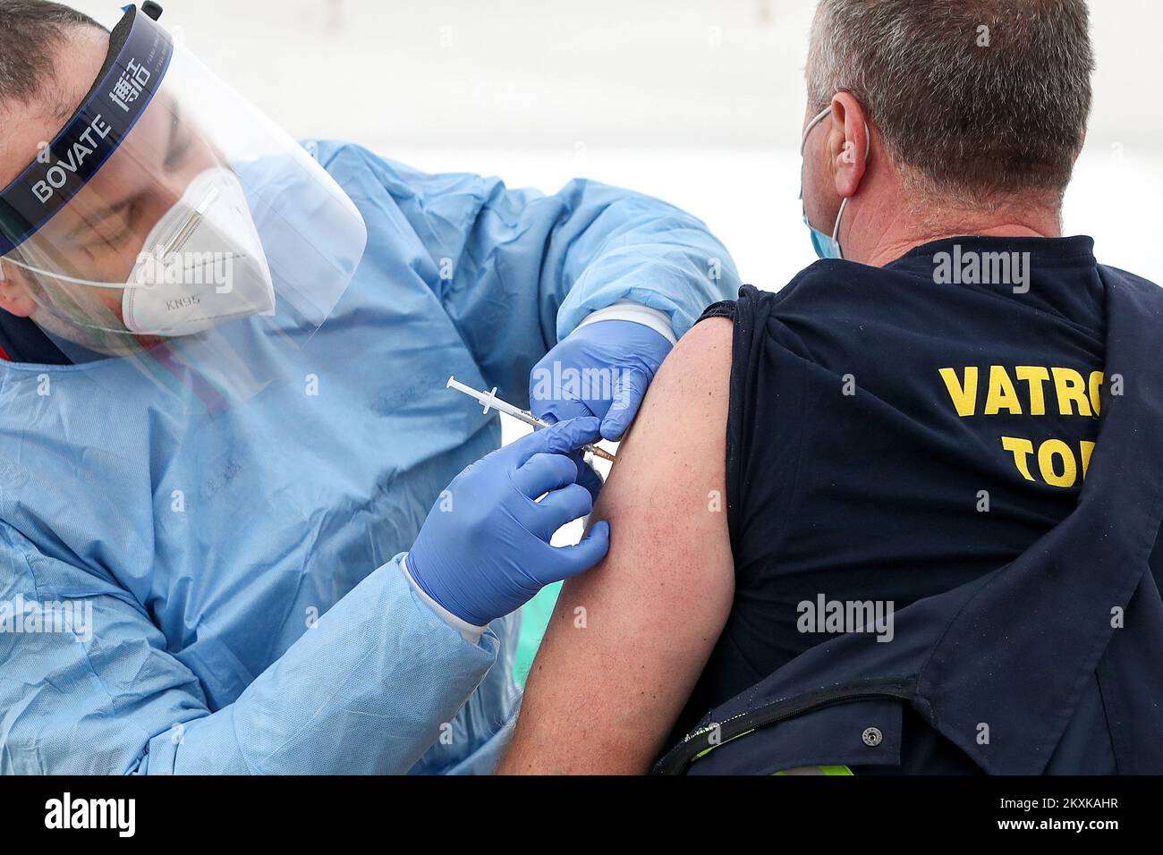 Emergency service worker receives a COVID-19 vaccine, in Petrinja ...