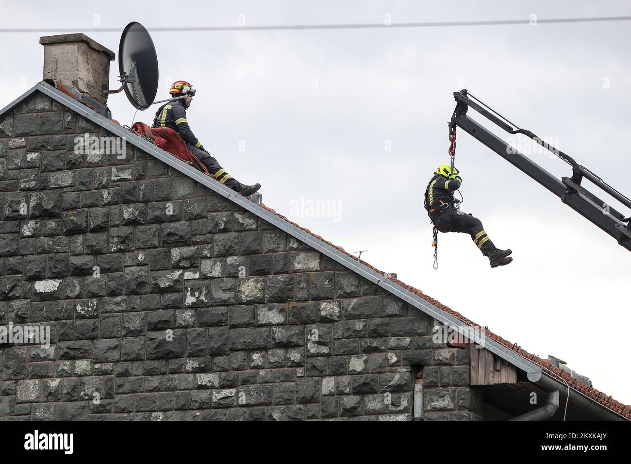 Firefighters repairing the damage on the roof which was damaged in ...