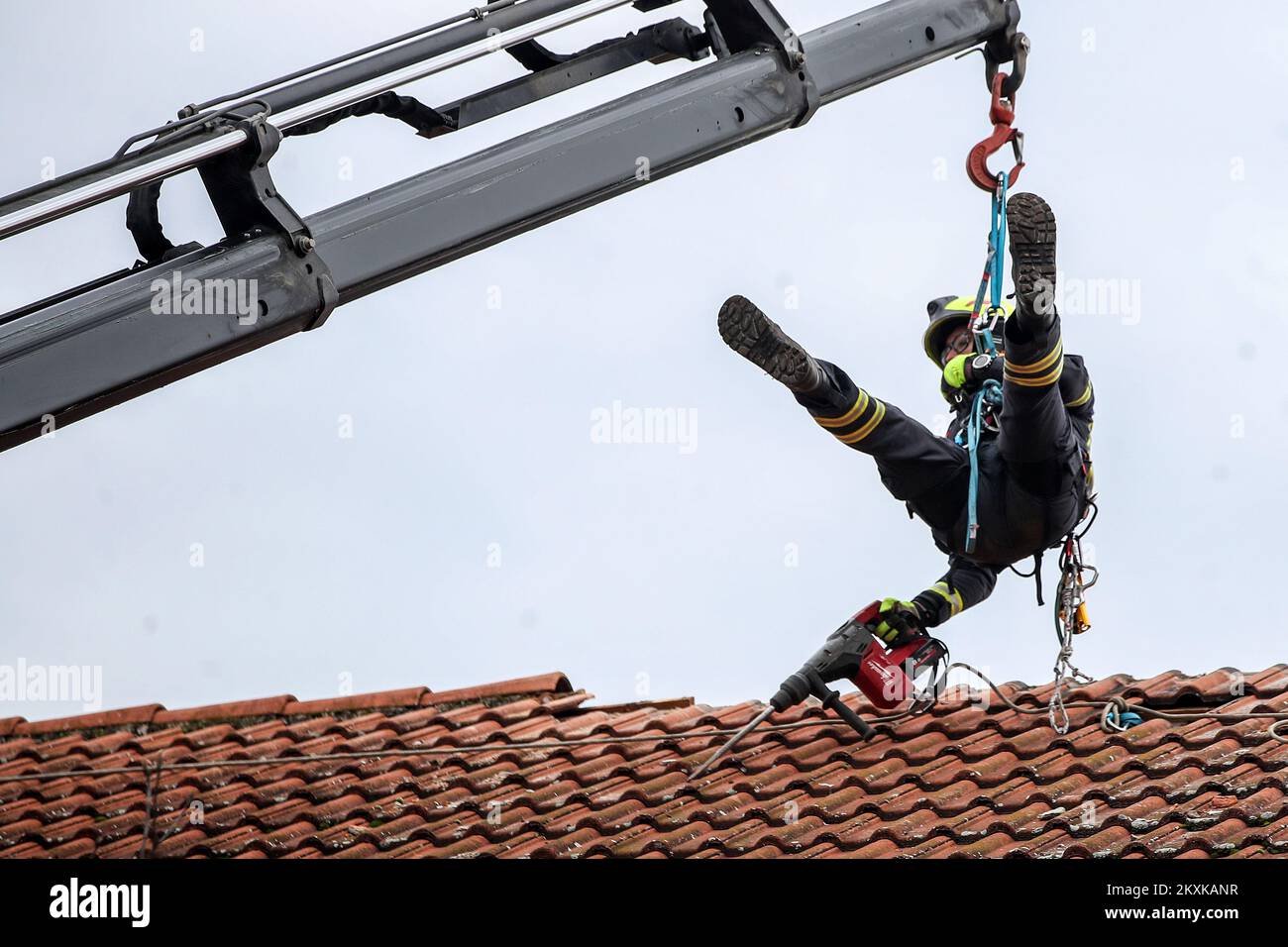 Firefighters repairing the damage on the roof which was damaged in ...