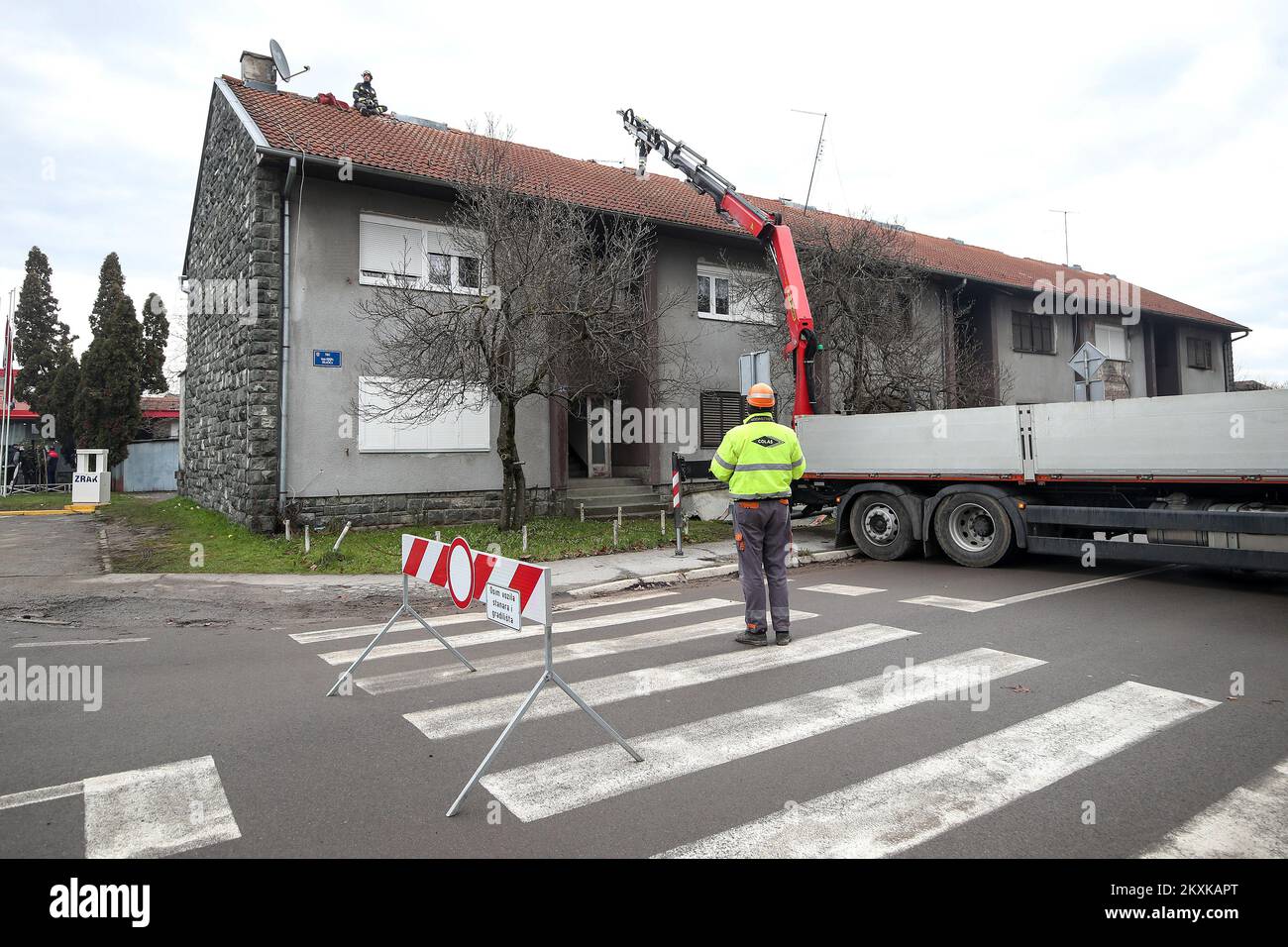 Firefighters repairing the damage on the roof which was damaged in ...