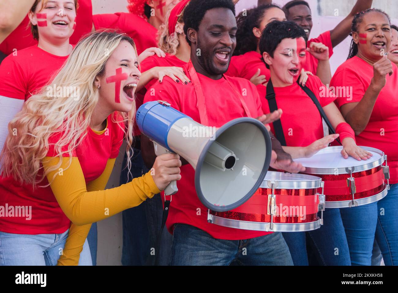 Group of fans cheering for their team together and having a fun time ...
