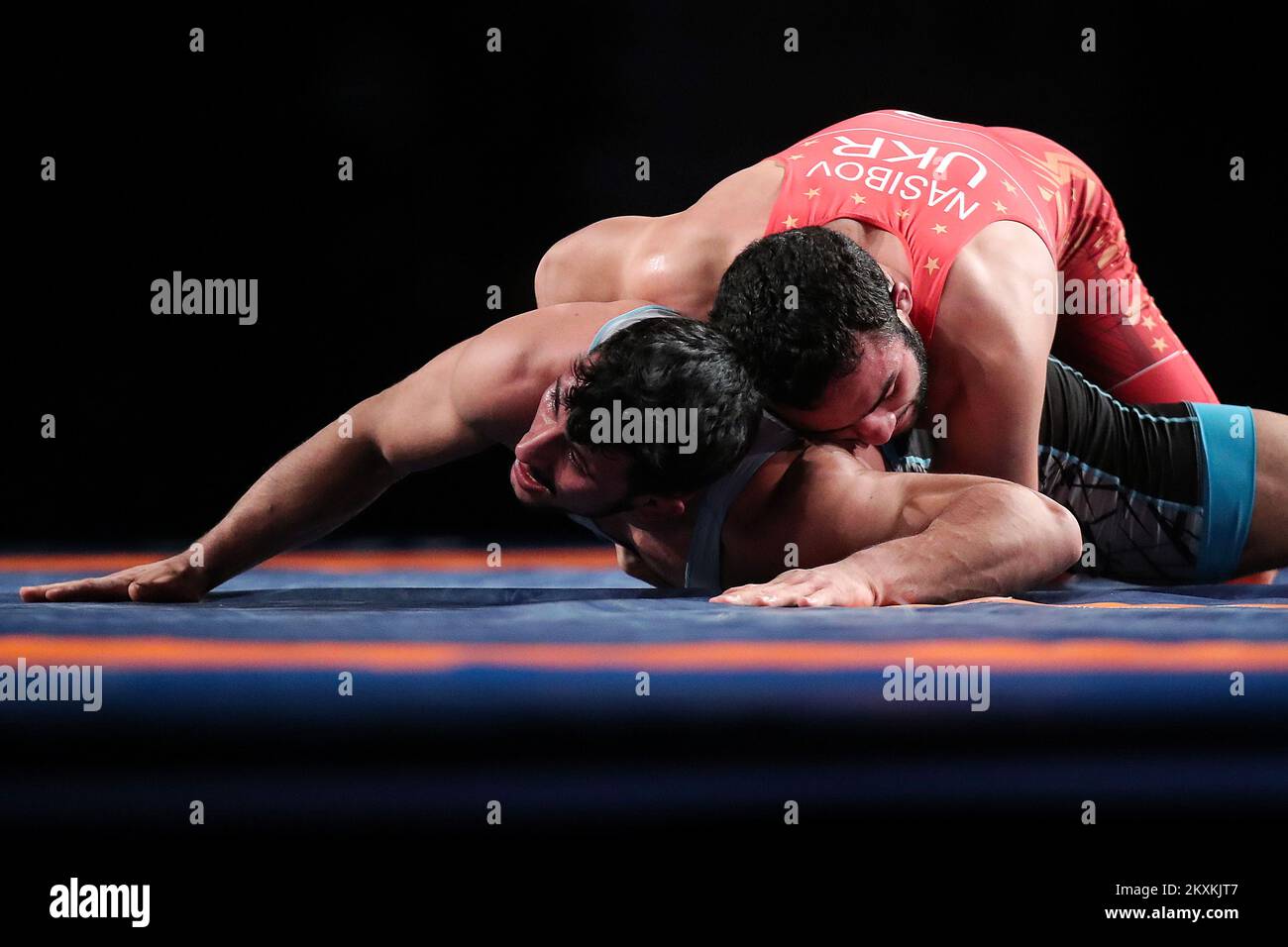 Parviz Nasibov of Ukraine (in red) fights with Ahmet Yilmaz of Turkey ...