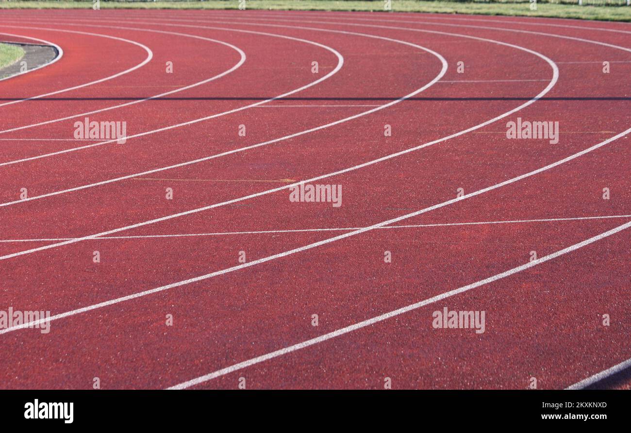 The Curves of an Athletics Track with a Red Surface Stock Photo - Alamy