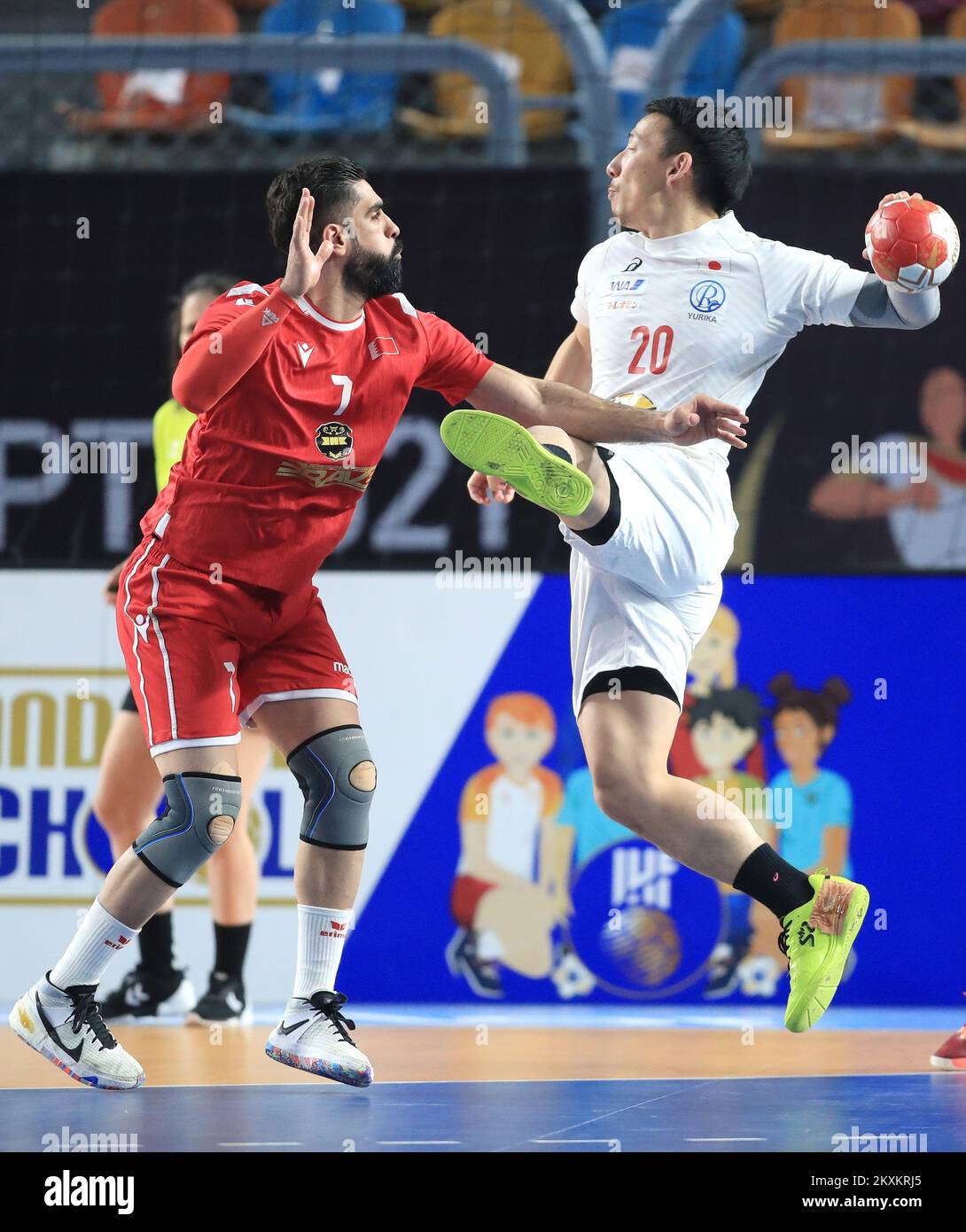Jin Watanabe of Japan is challenged by Ali Merza of Bahrain during the ...