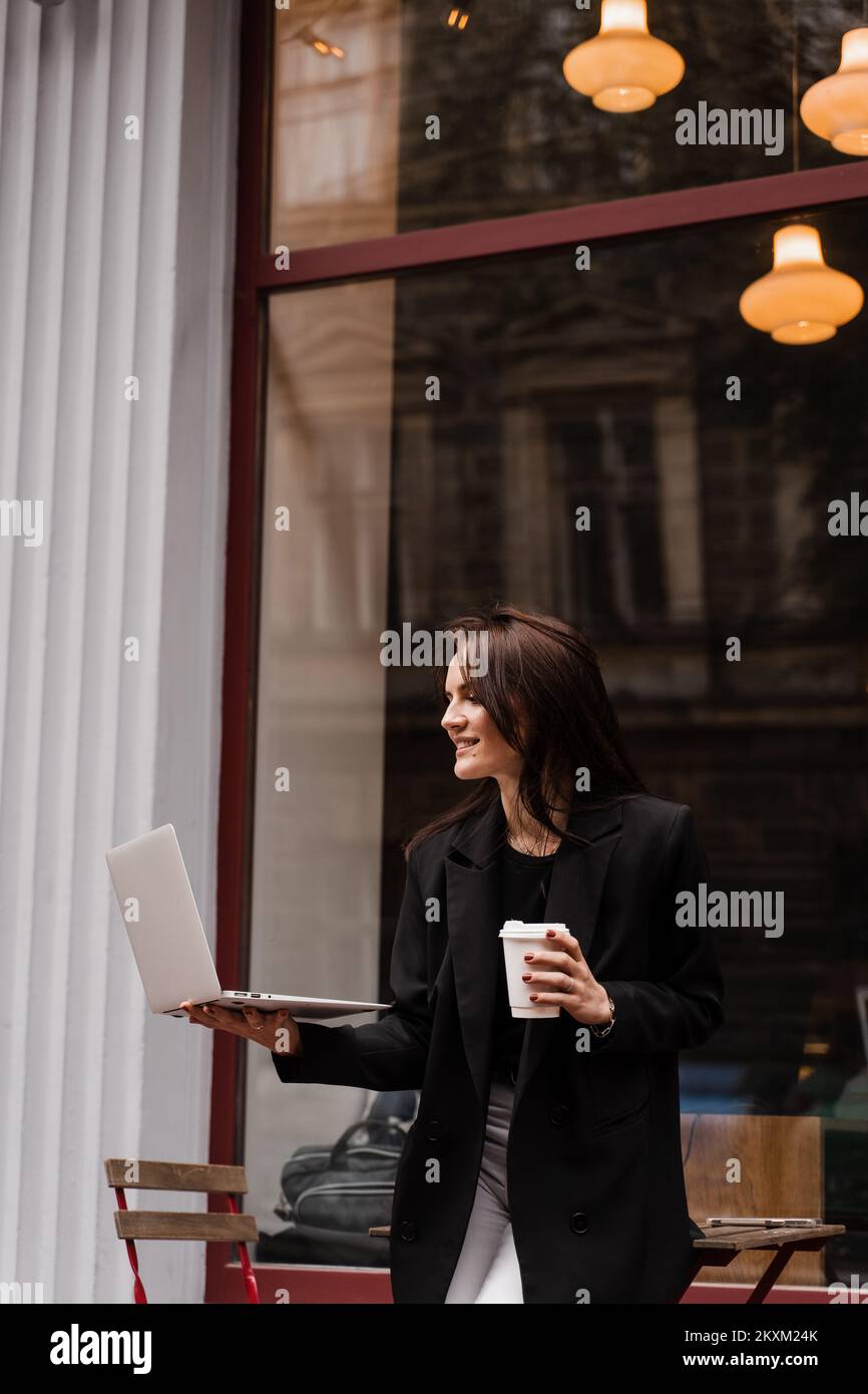 Confident young business woman working online with team on laptop on ...