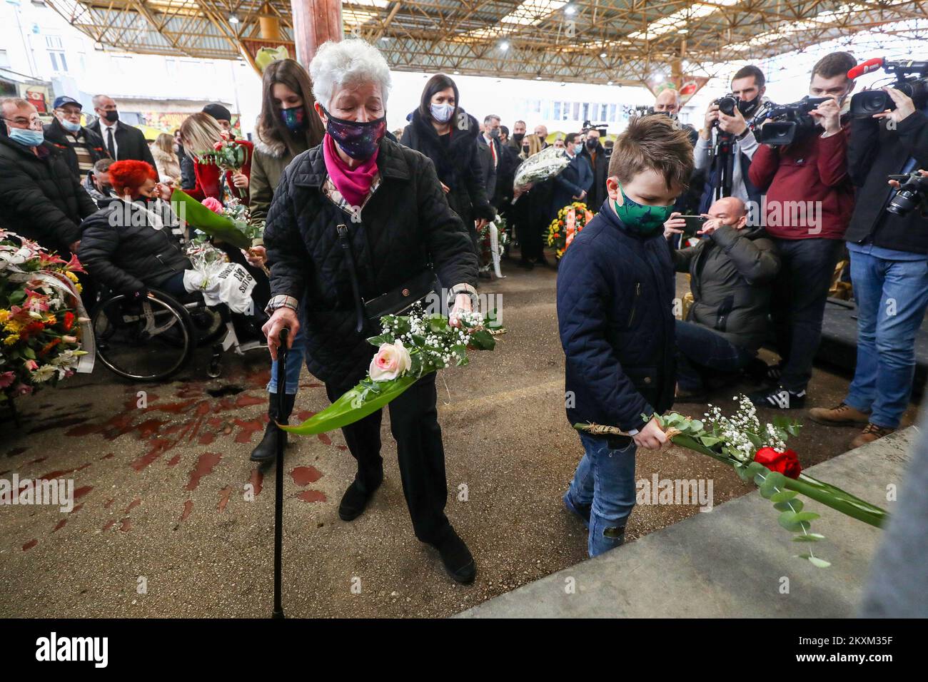People are seen paying tribute at the commemoration for the victims of ...