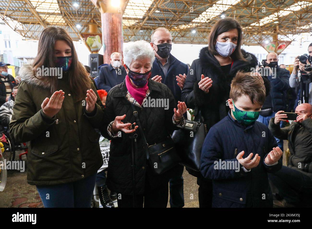 People are seen paying tribute at the commemoration for the victims of ...