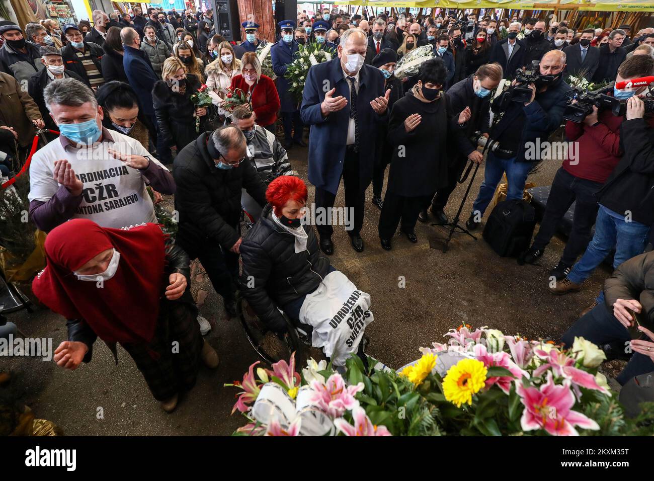 People are seen paying tribute at the commemoration for the victims of ...