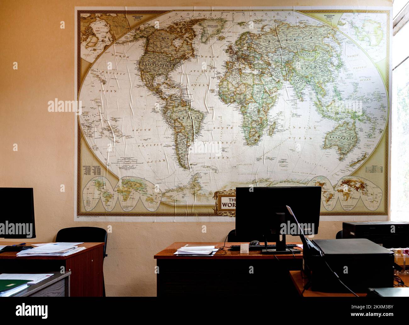 A fragment of an office room with a large map of the world Stock Photo ...