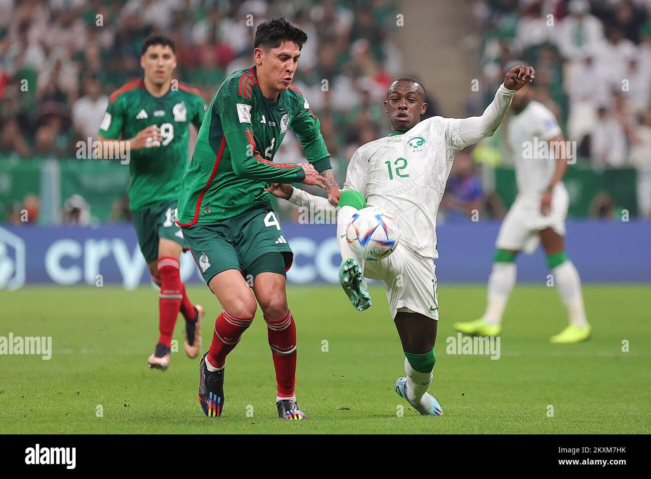 Lusail, Qatar. 30th Nov, 2022. Saud Abdulhamid (R) of Saudi Arabia vies ...