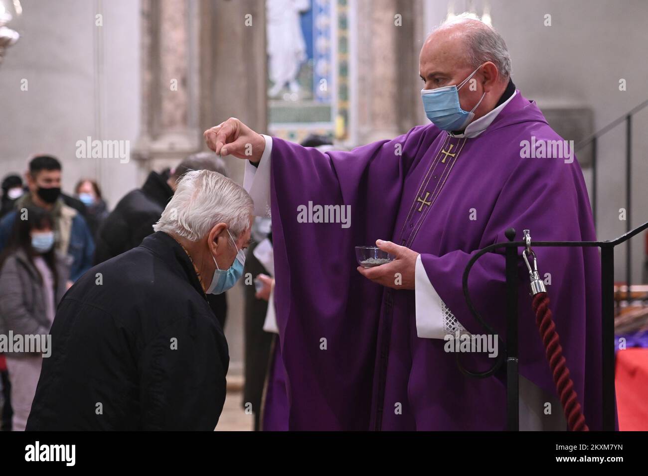 Priest sprinkles ash on man's head during the Ash Wednesday mass to ...