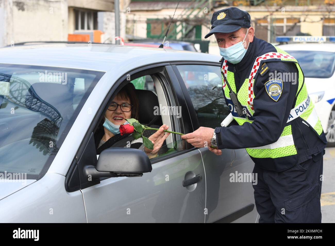 Police officer posing with the woman after giving her rose, in Sibenik ...