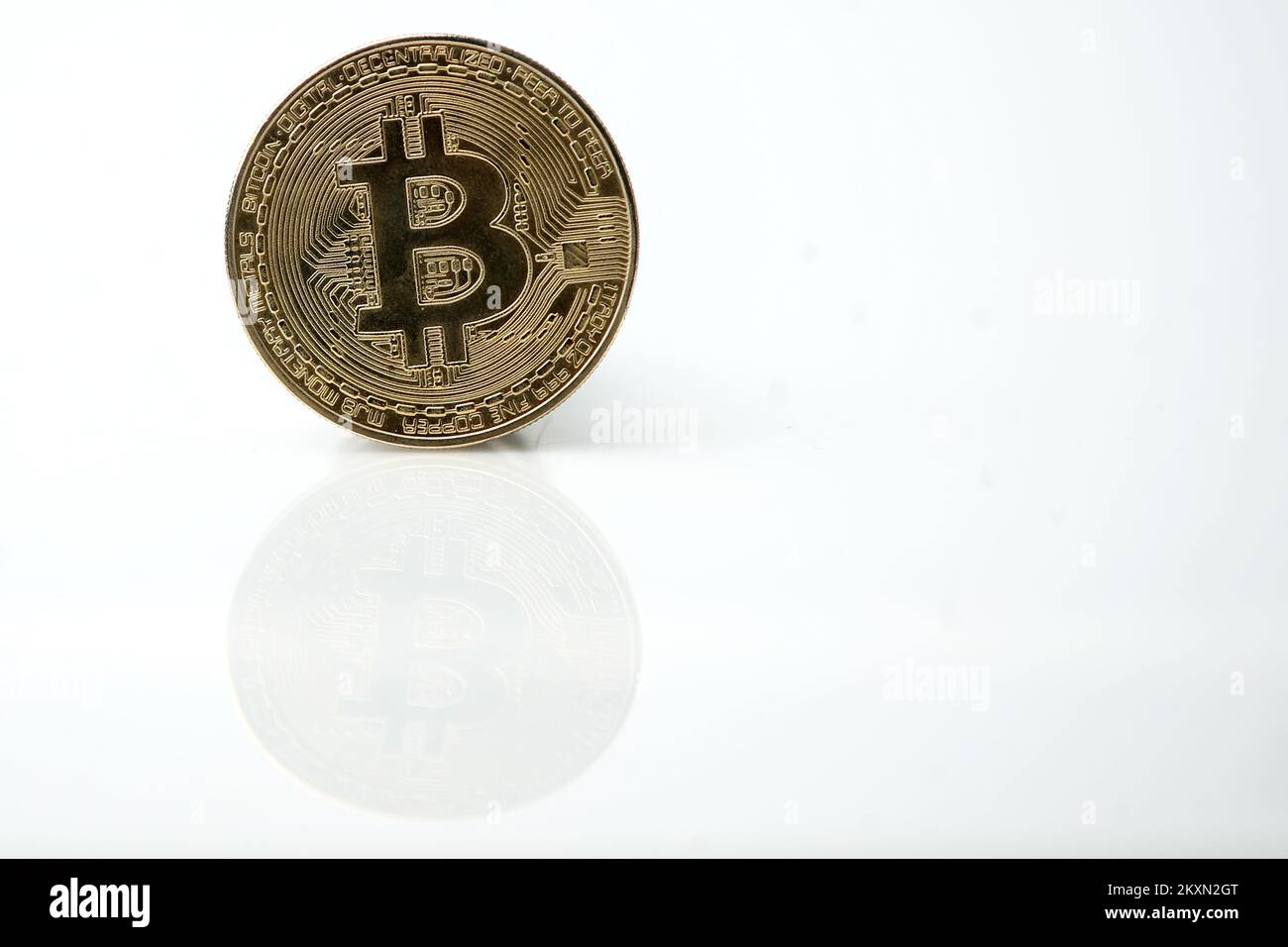Representations of virtual currency Bitcoin is seen placed on white ...