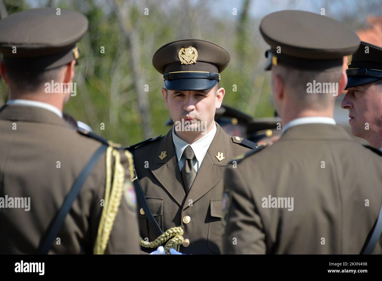 The pictures show soldiers in ceremonial uniforms. The 100th ...