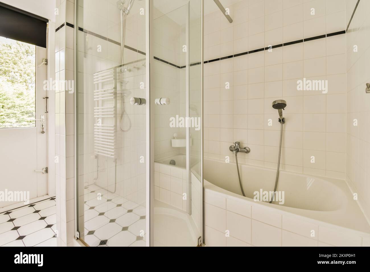 Contemporary bathroom with bathtub and glass shower cabin with light ...