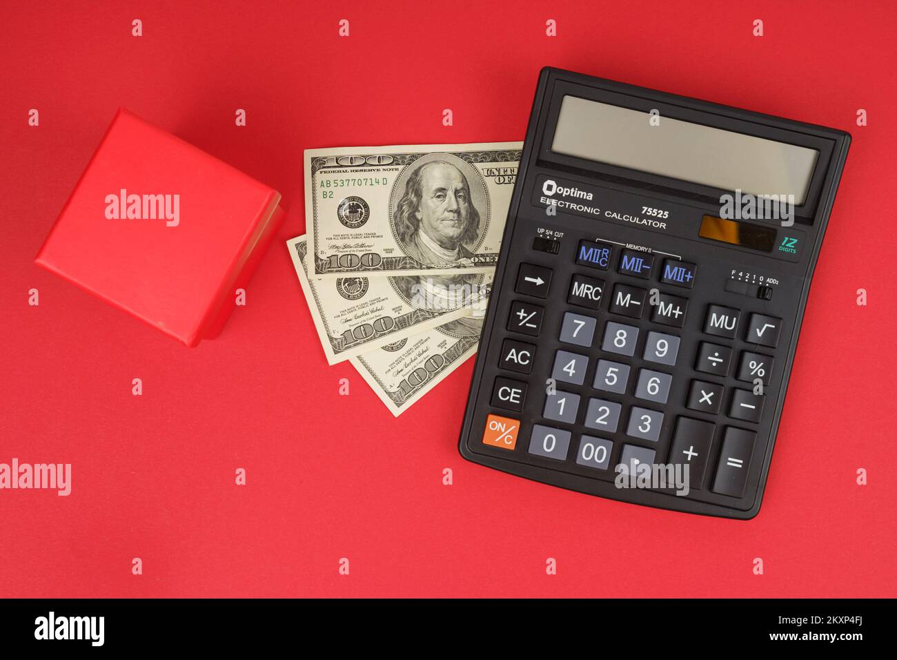 Business and finance concept. Money, a calculator and a red gift box ...