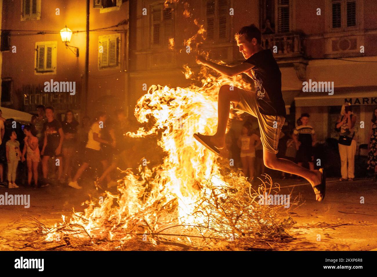 Children jumping through bonfire in Vodnjan, Croatia on 23. June 2021 ...