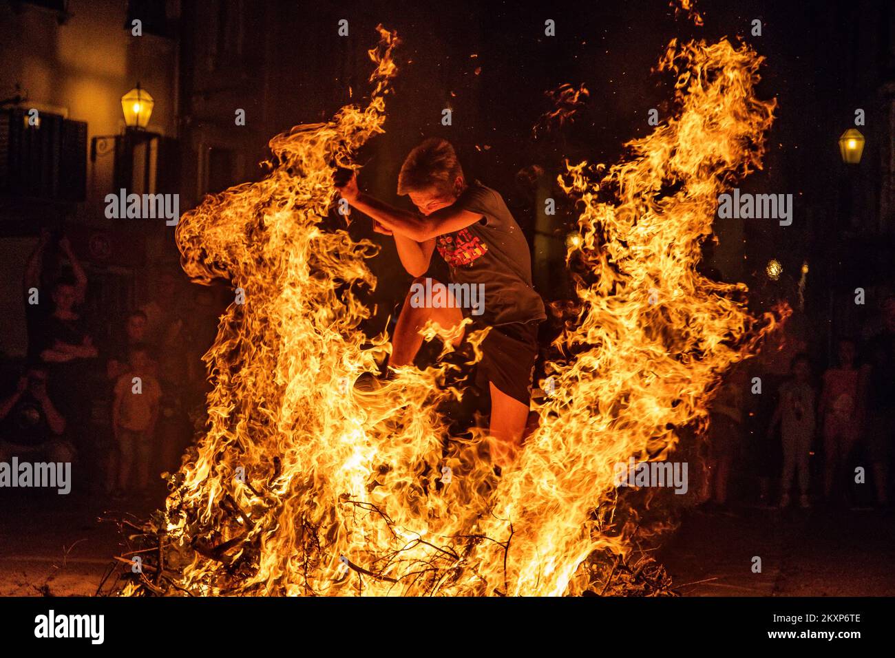 Children jumping through bonfire in Vodnjan, Croatia on 23. June 2021 ...