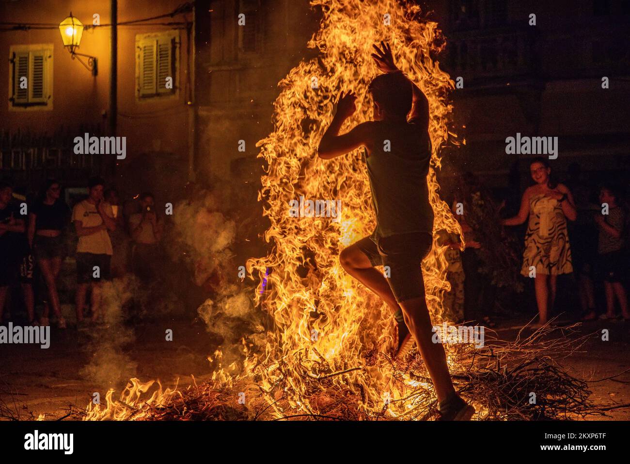 Children jumping through bonfire in Vodnjan, Croatia on 23. June 2021 ...