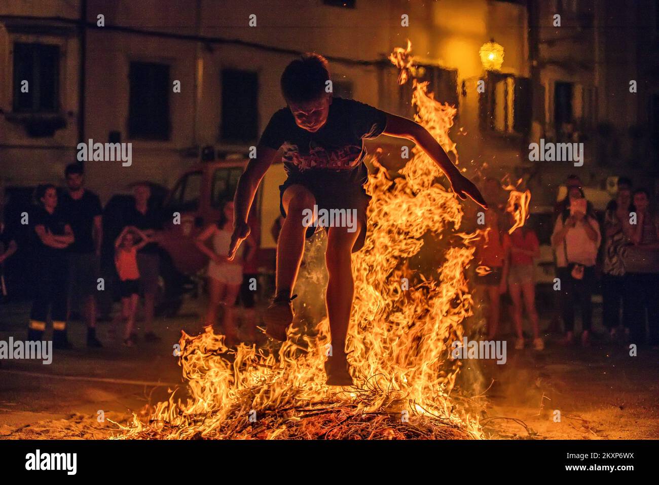 Children jumping through bonfire in Vodnjan, Croatia on 23. June 2021 ...
