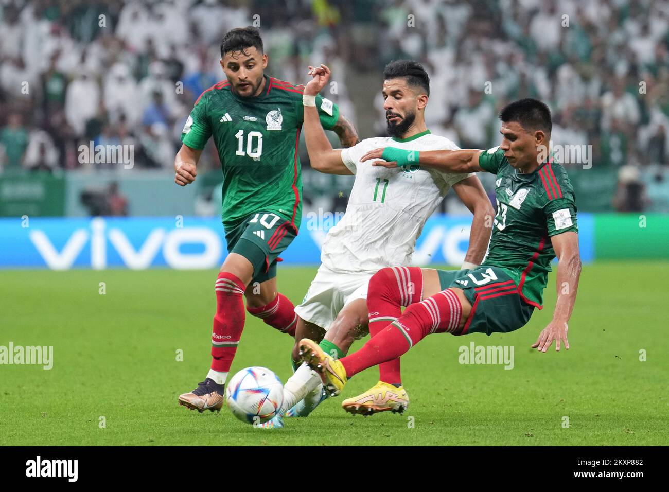 Lusail, Qatar. 30th Nov, 2022. Saleh Alshehri (C) of Saudi Arabia vies ...
