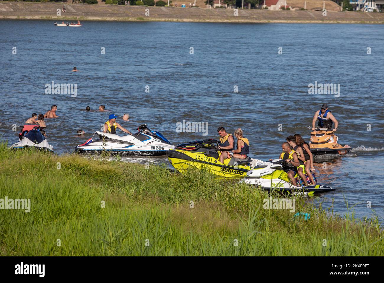 People enjoy the sun at popular beach Kopika ,on the Drava river, in ...