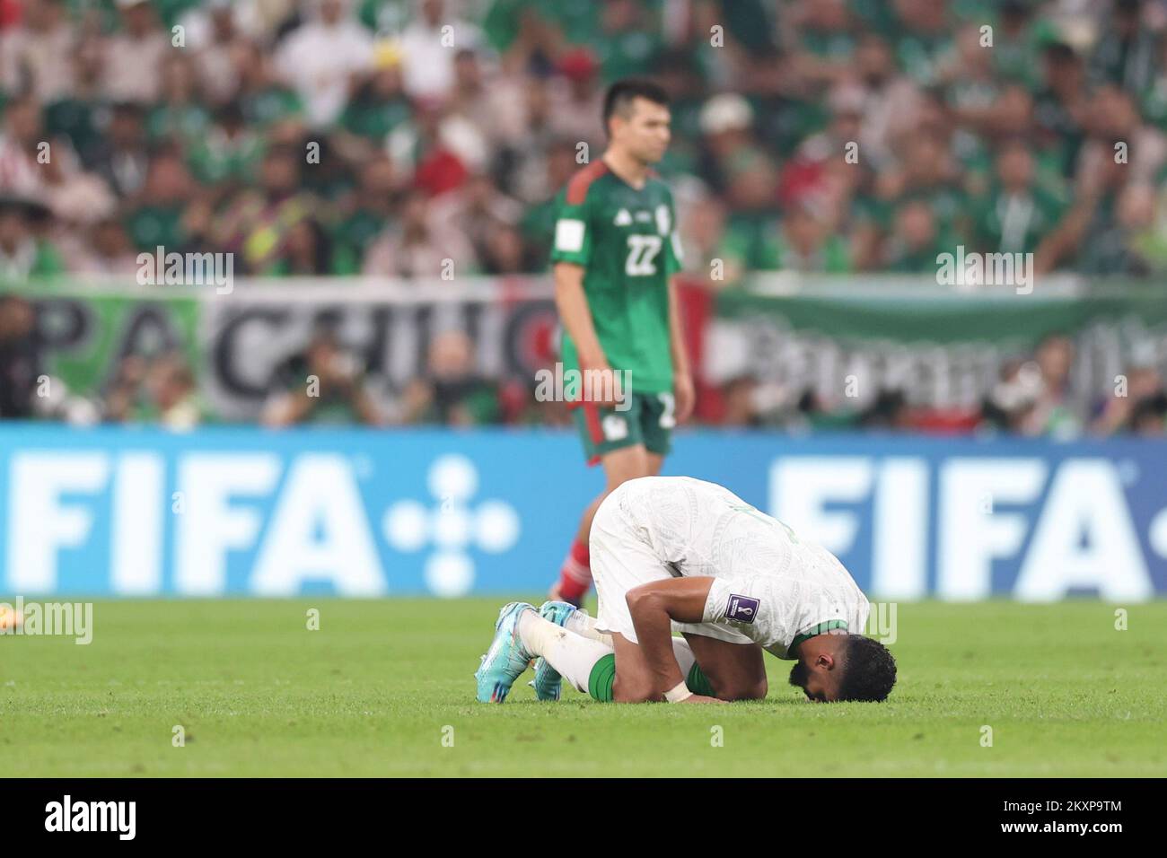 Lusail, Qatar. 30th Nov, 2022. Abdulelah Alamri (below) of Saudi Arabia ...