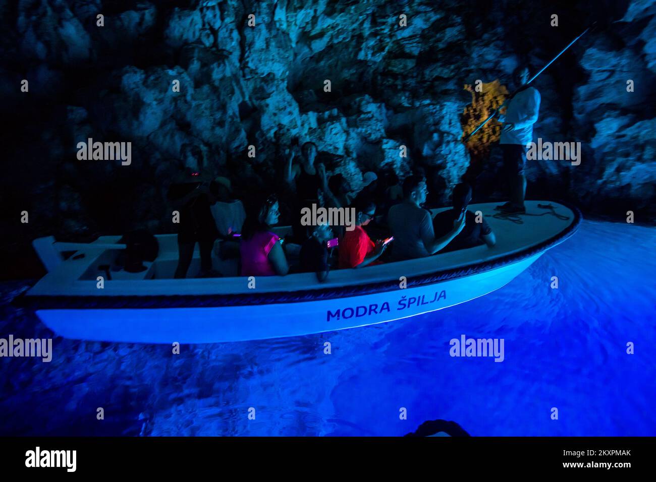 Tourists seen in boats visiting the Blue Cave, on Bisevo Island ...