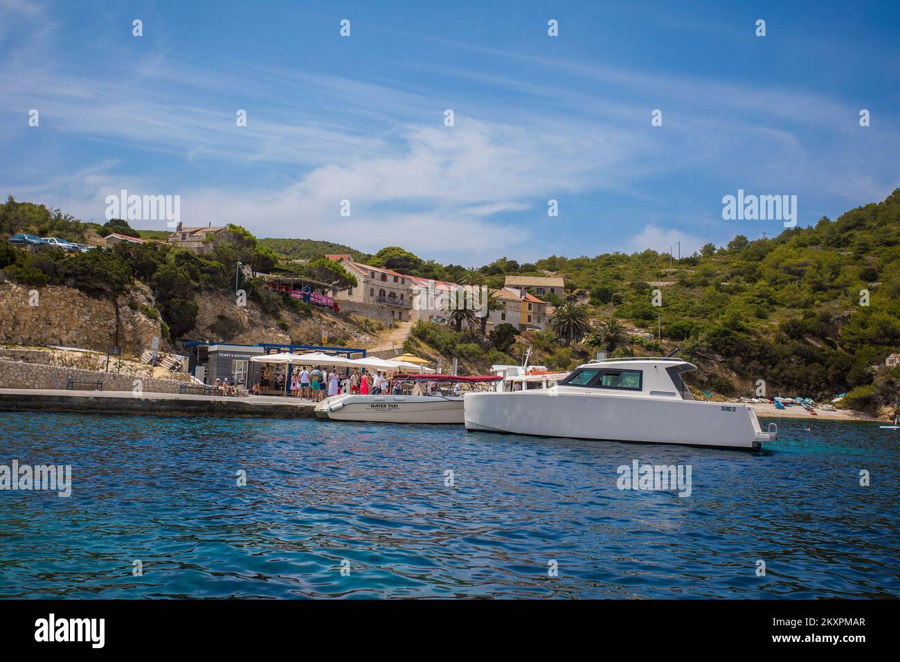 Tourists seen in boats , traveling to visit The Blue Cave, on Bisevo ...