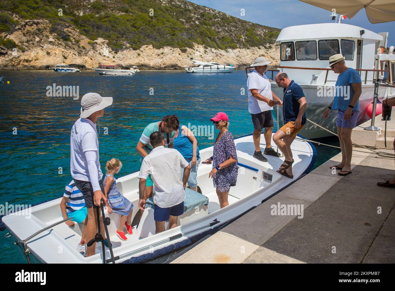 Tourists seen in boats , traveling to visit The Blue Cave, on Bisevo ...