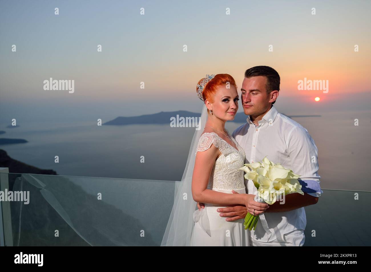 Beautiful young couple bride and groom posing on Santorini island ...