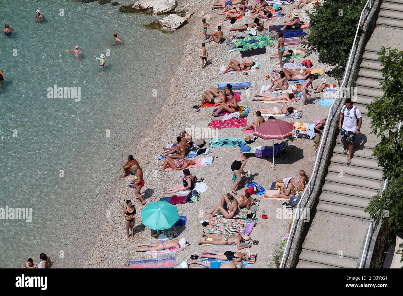 Swimmers enjoy in Sablicevo beach in Rijeka on July 24, 2021. Sablicevo is the most beautiful ...
