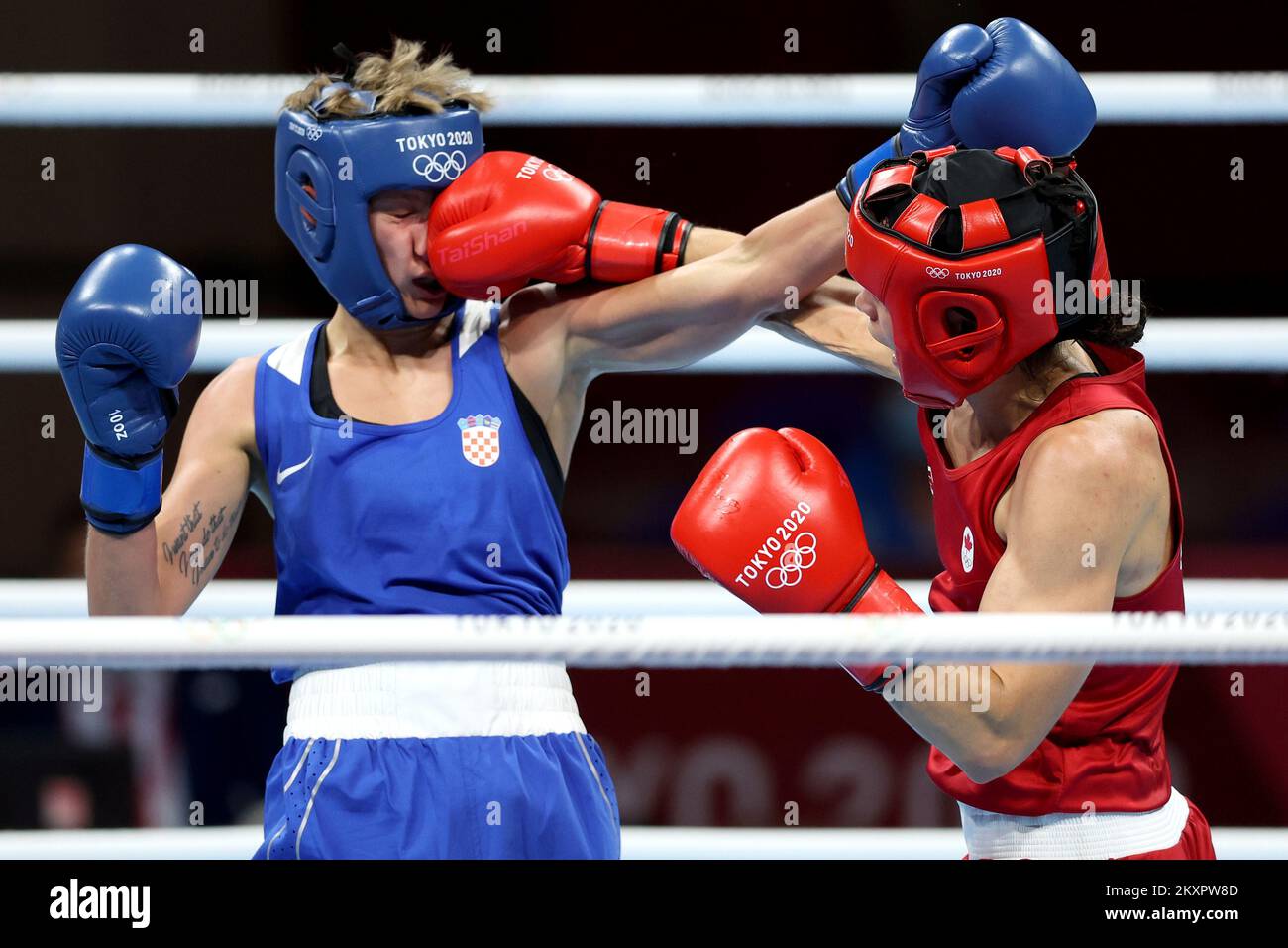 Caroline Veyre (R) of Canada exchanges punches with Nikolina Cacic (L ...