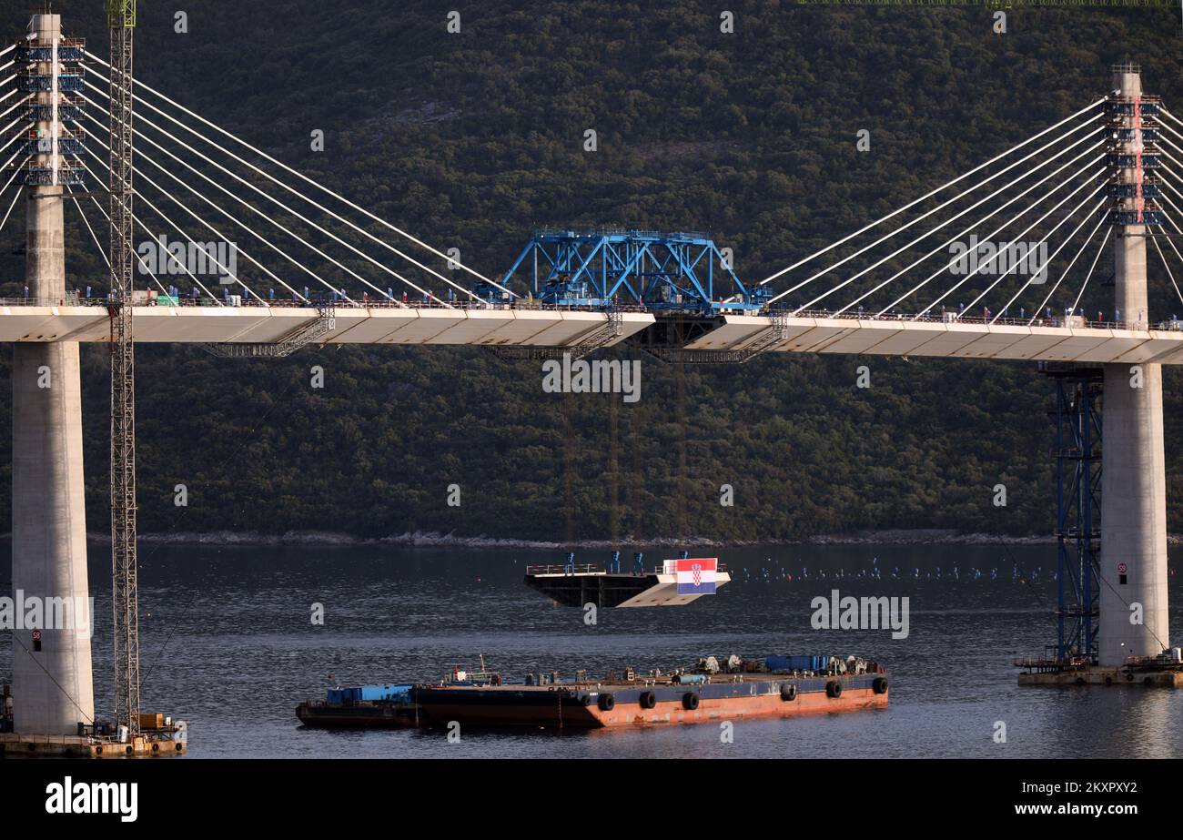 With the installation of the last, 165th segment of the steel span of ...