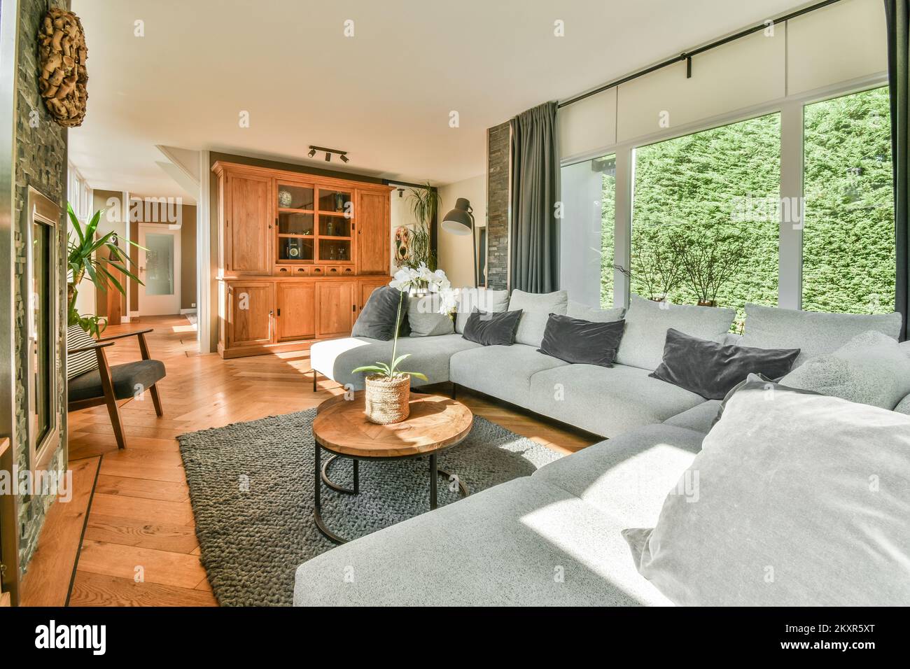 Table with chairs and flowers located near lounge area and kitchen in ...