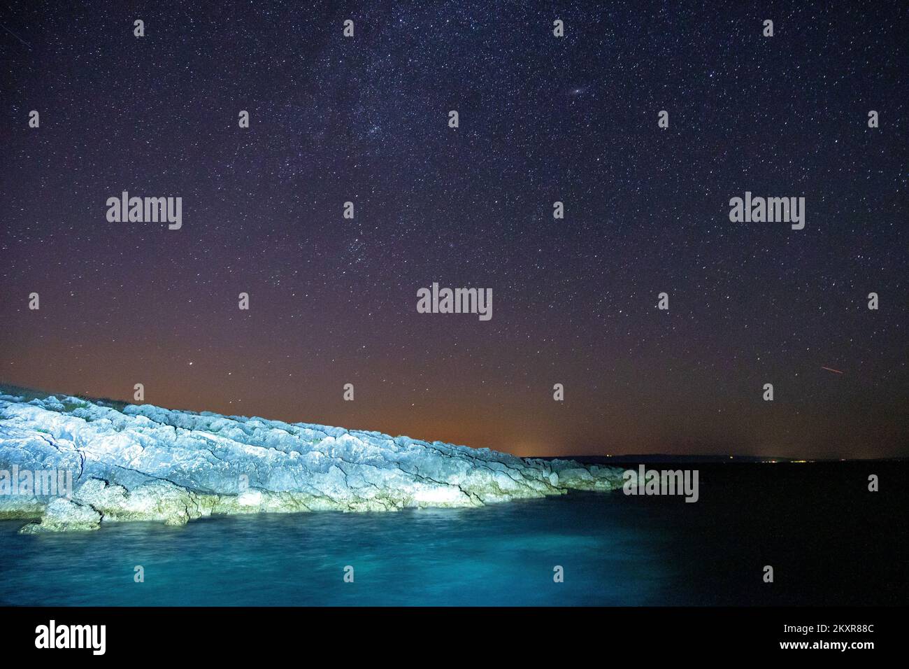 Perseids in the night sky photographed near the lighthouse Rt Marlera ...