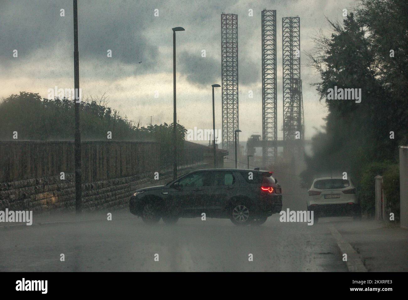 Traffic during heavy rain and clouds after few weaks of heat above city ...